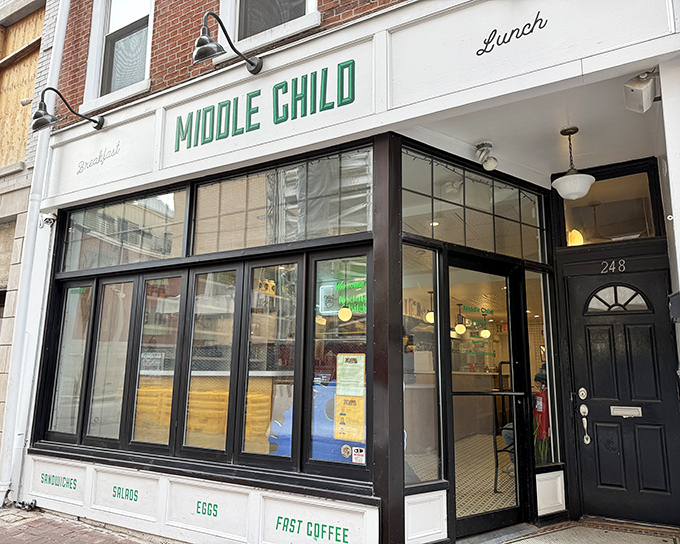 The storefront beckons like a friendly neighbor, with its crisp white facade and bold green lettering promising breakfast delights that'll make your morning infinitely better.