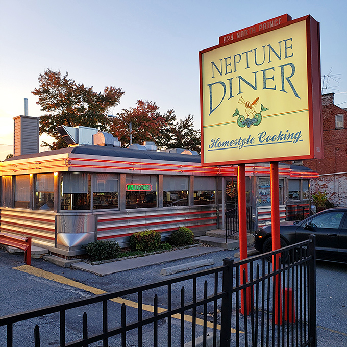 The classic stainless steel exterior of Neptune Diner gleams in the evening light, a beacon of comfort food promising homestyle cooking to hungry travelers.