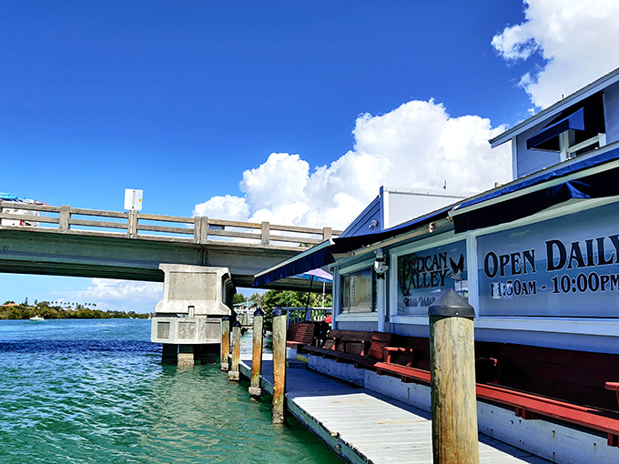 Waterfront perfection! Pelican Alley sits right beneath the Nokomis Bridge, where turquoise waters and Florida sunshine create the ultimate dining backdrop.