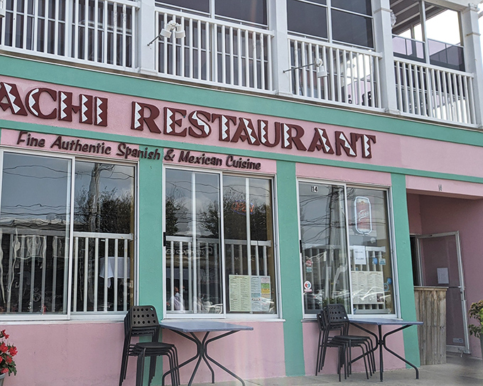 The pastel pink and mint green exterior of Mariachi Restaurant stands out like a cheerful beacon among Rehoboth's beachside buildings, promising authentic flavors within.