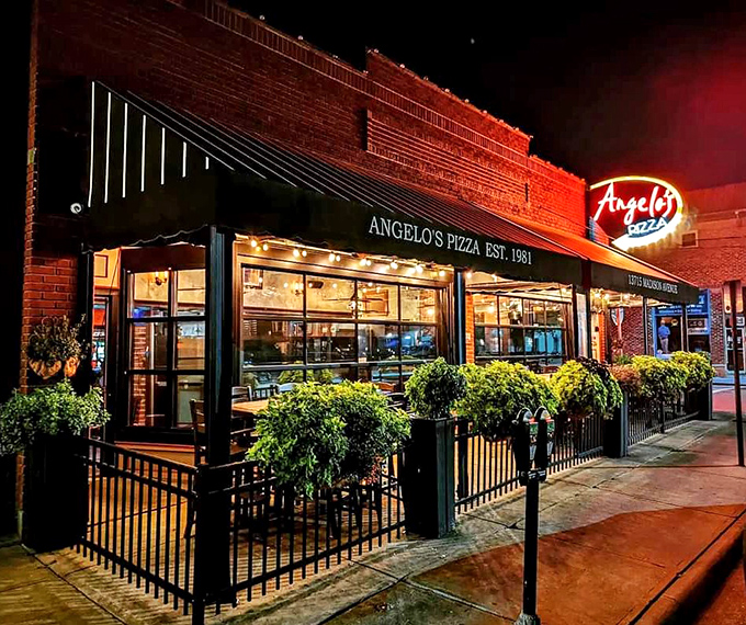 The iconic Angelo's Pizza storefront on Madison Avenue beckons with its vintage neon sign and flower-adorned patio—a Cleveland culinary landmark worth the pilgrimage.