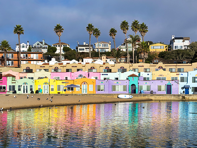 Capitola's famous rainbow-hued Venetian Court apartments reflect in the lagoon like a watercolor painting that somehow escaped the frame and decided to become architecture instead.