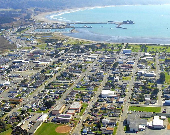 Crescent City unfolds like a perfect miniature model town, with its grid of streets embracing the harbor's gentle curve and the Pacific stretching endlessly beyond.