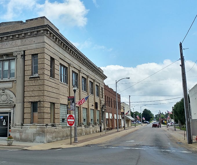 Downtown Kennett welcomes you with classic Americana charm. American flags flutter above storefronts where your dollar stretches like it's 1985.