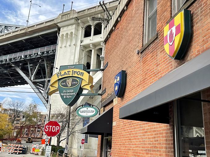 The Flat Iron Cafe stands proudly in Cleveland's Flats district, its brick facade and heraldic shields offering just a hint of the Irish hospitality waiting inside.