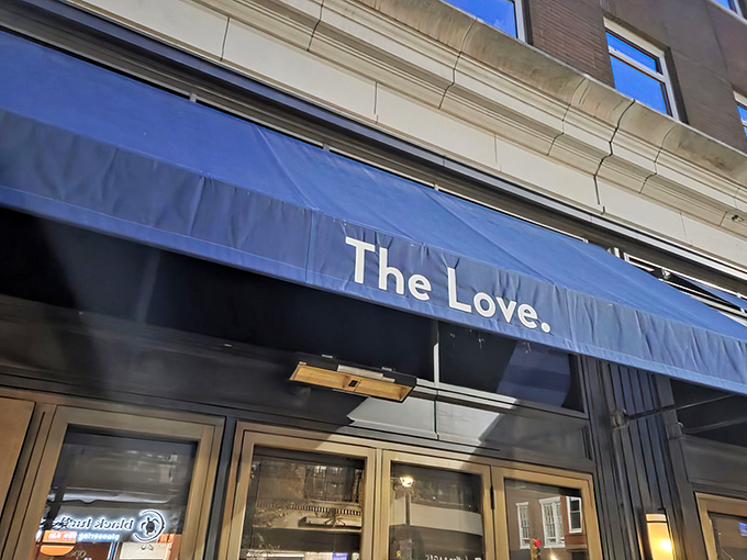The iconic blue awning of The Love stands out in Philadelphia's Rittenhouse Square like a beacon for hungry souls seeking culinary salvation.