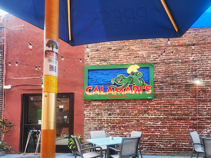 The iconic Calamari's exterior welcomes you with exposed brick, a cheerful cartoon squid, and the promise of seafood delights in downtown Erie.
