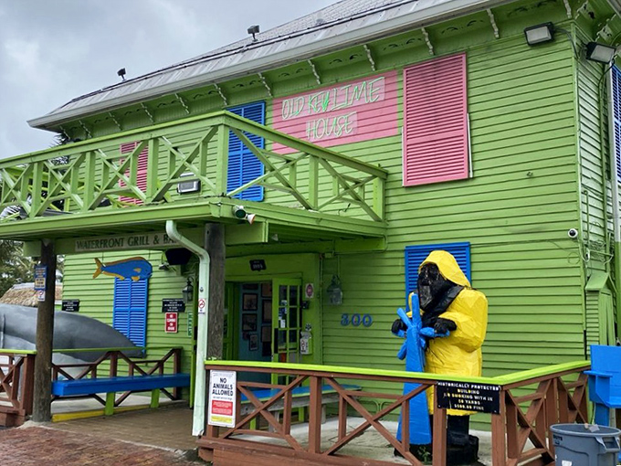 The lime-green facade of Old Key Lime House stands out like a tropical oasis against Florida's blue sky, beckoning hungry travelers with its Caribbean charm.