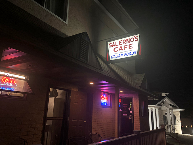 By night, Salerno's neon sign serves as a beacon for hungry travelers and locals alike, promising Italian comfort in the heart of Old Forge.