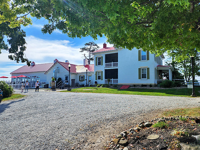 The classic white farmhouse with its striking red roof stands like a culinary lighthouse, beckoning hungry travelers to the rolling hills of Adena.