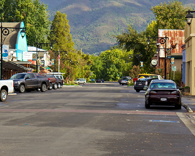 Main Street stretches toward the mountains like a postcard from simpler times, where pickup trucks outnumber sedans and nobody's in a hurry.