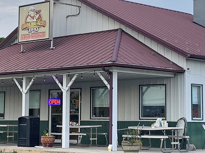 The humble white building with its burgundy roof might not look fancy, but that cartoon pig in sunglasses knows something you don't&mdash;barbecue paradise awaits inside.