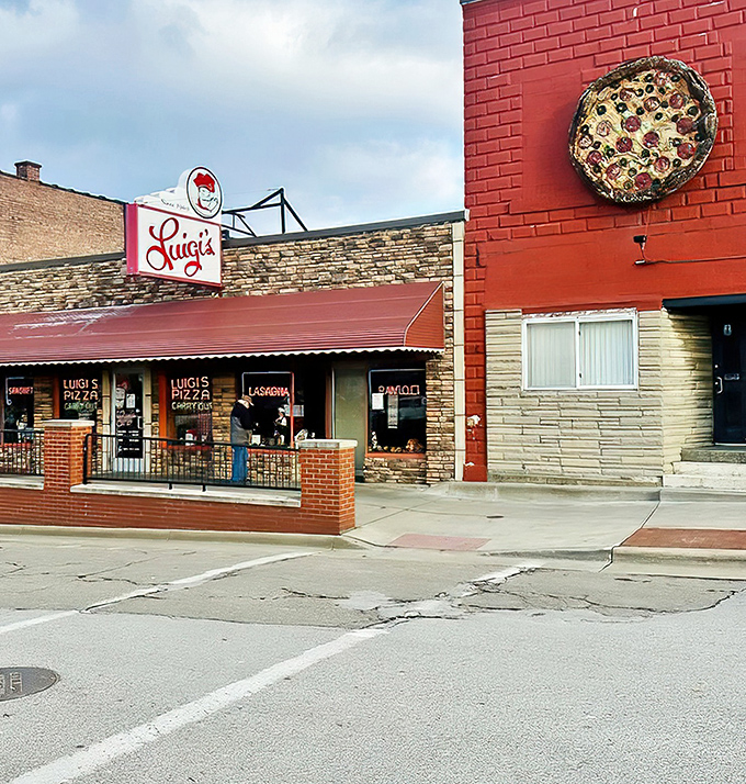 Luigi's iconic red brick exterior stands as a beacon of pizza perfection in Akron, complete with that charming vintage sign that's been guiding hungry patrons for generations.