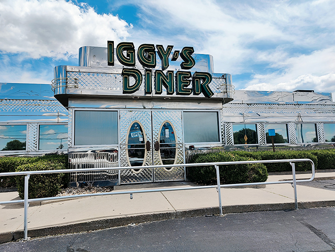 The gleaming stainless steel exterior of Iggy's Diner shines like a beacon on Route 66, promising classic American comfort with a side of nostalgia.