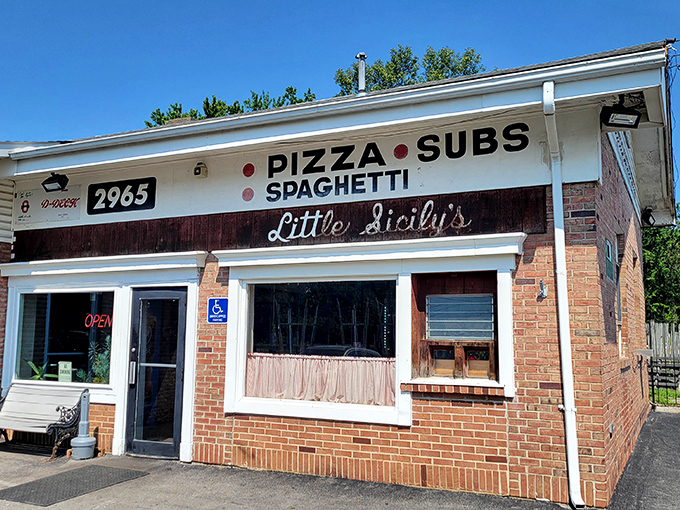 Little Sicily's unassuming brick exterior is like that friend who doesn't brag but always delivers. Those pink curtains have witnessed decades of pizza perfection. 