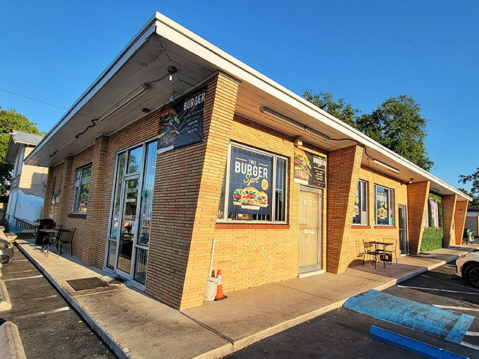 The unassuming yellow brick exterior of Thee Burger Spot stands like a culinary fortress, promising treasures that no fancy architecture could ever outshine.