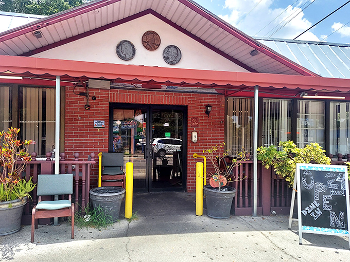 Three coins on the facade aren't just decoration—they're a promise of the culinary treasures waiting inside this unassuming Tampa landmark.