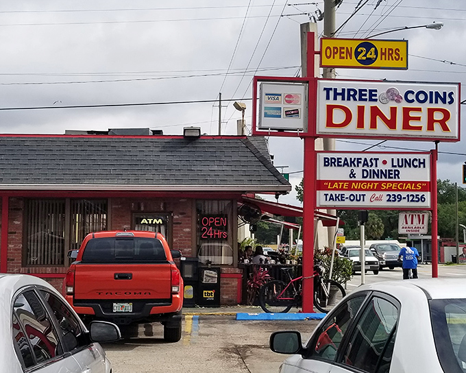 The classic red "DINER" sign beckons like an old friend, promising comfort food and conversations that flow as freely as the coffee.