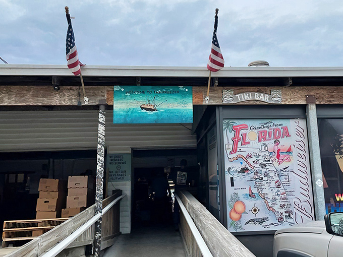 American flags flank the entrance to this unassuming seafood sanctuary, where a hand-painted Florida map promises authentic coastal flavors await inside.