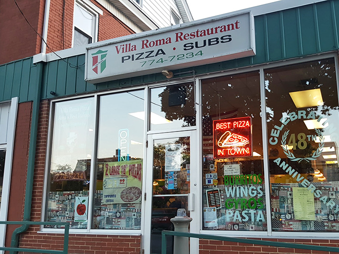 The unassuming storefront of Villa Roma beckons with its "BEST PIZZA IN TOWN" neon promise &ndash; a humble declaration that locals know isn't just empty boasting.