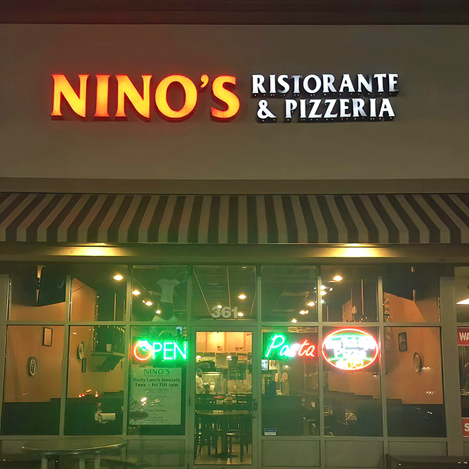 The glowing sign of Nino's beckons like a lighthouse for the hungry, promising Italian treasures within its modest storefront.