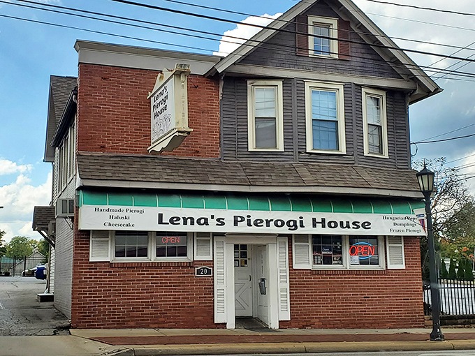 The sign says it all! Lena's Pierogi House welcomes hungry visitors with its whimsical dancing dumplings, promising Eastern European comfort in Hubbard's heart.