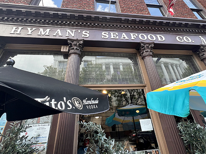 The historic brick fa&ccedil;ade of Hyman's Seafood stands proudly on Meeting Street, flags waving like a maritime welcome committee for hungry visitors.