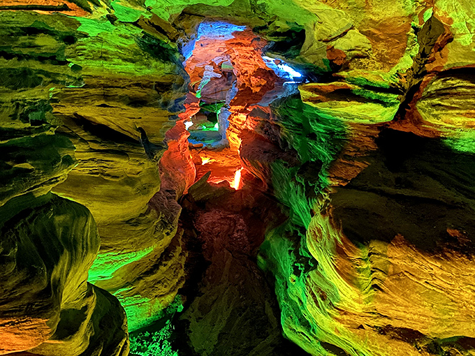 Nature's light show on full display! The vibrant illumination transforms these ancient sandstone formations into a psychedelic underground dreamscape that feels straight out of a sci-fi film.