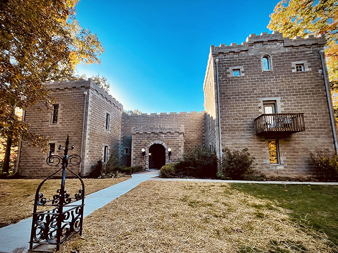 Twilight transforms Ravenwood Castle into a magical realm, its stone walls aglow with warm light that beckons weary travelers into this medieval fantasy tucked away in Ohio's forests.