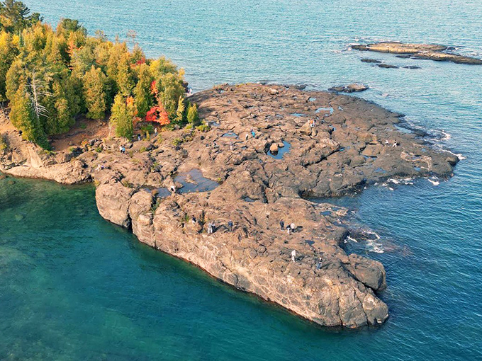 Lake Superior's emerald waters frame these ancient volcanic rocks like nature's own jewelry display.