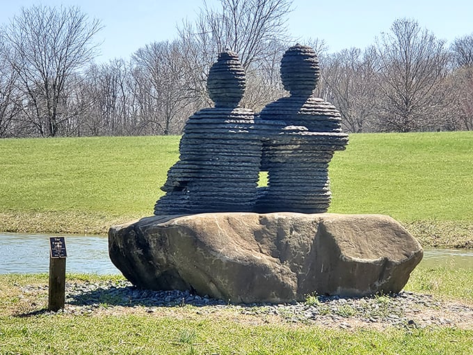 Two figures eternally connected in slate-like layers, proving that even in art, we're better together than apart.