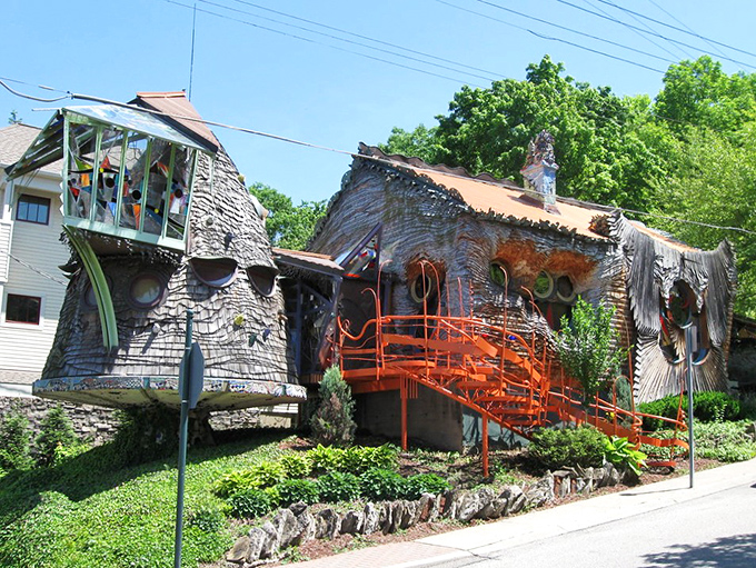 The Mushroom House stands proudly against a blue Ohio sky, its wooden shingles and porthole windows creating a fairytale vision in suburban Cincinnati.