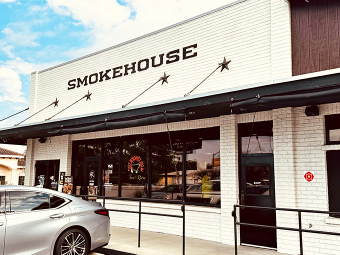 The white brick façade might look unassuming, but that "SMOKEHOUSE" sign is actually Florida's version of a heavenly welcome mat.