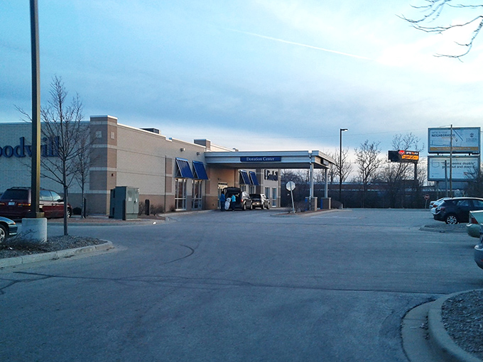 The unassuming exterior of Milwaukee's treasure trove beckons at dusk, blue awnings signaling the thrifting adventure that awaits inside.