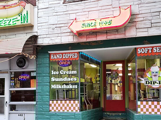 The iconic turquoise storefront beckons with its vintage neon arrow. At The Squeeze-In, the name isn't just clever marketing&mdash;it's a literal description.