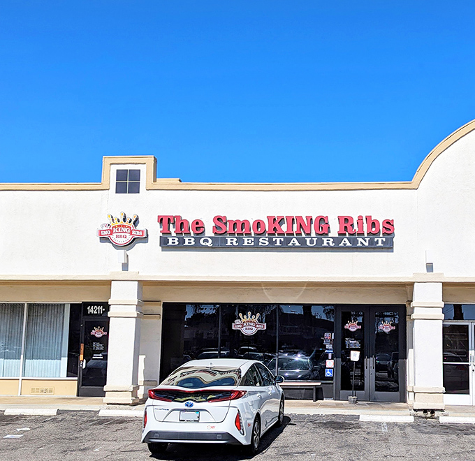 The bold red sign against the clear blue California sky isn't just advertising &ndash; it's a beacon for barbecue pilgrims seeking smoky salvation in Garden Grove.