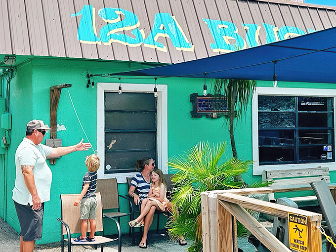 The turquoise exterior of 12A Buoy stands out like a tropical oasis, promising seafood treasures within its unassuming walls.