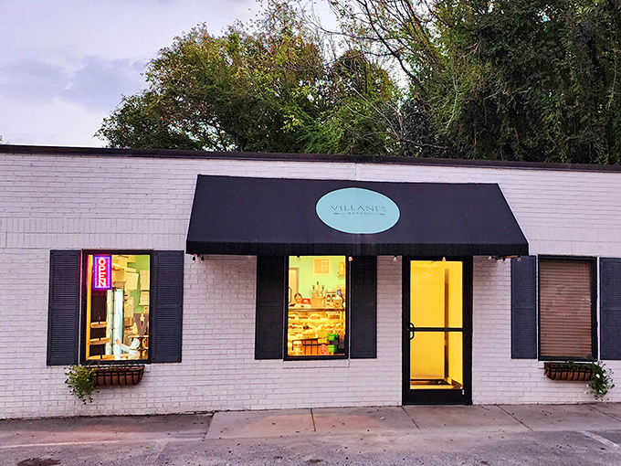 The charming white brick exterior of Villani's Bakery beckons like a sweet siren call, its teal logo and black awning promising Italian delights within.