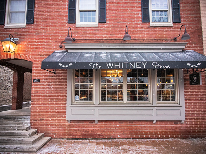 The Whitney House's charming brick exterior and classic black awning invite you in like an old friend who happens to be an exceptional cook.