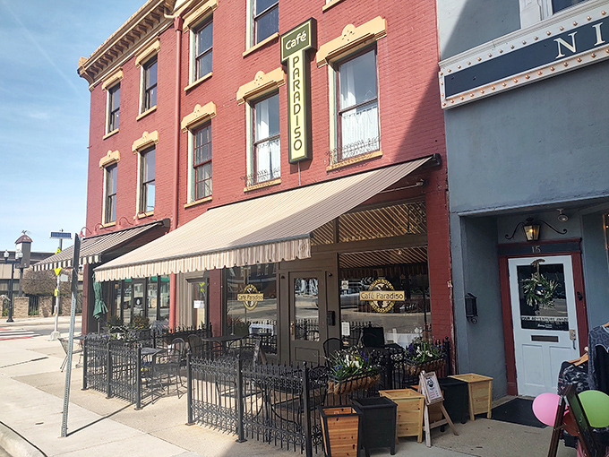 The charming brick fa&ccedil;ade of Caf&eacute; Paradiso brings a touch of European elegance to downtown Urbana, complete with inviting outdoor seating perfect for people-watching.