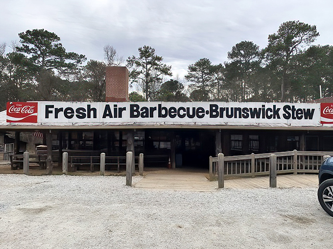 The iconic sign says it all: Fresh Air Barbecue and Brunswick Stew, flanked by Coca-Cola logos—a roadside beacon for barbecue pilgrims since 1929.