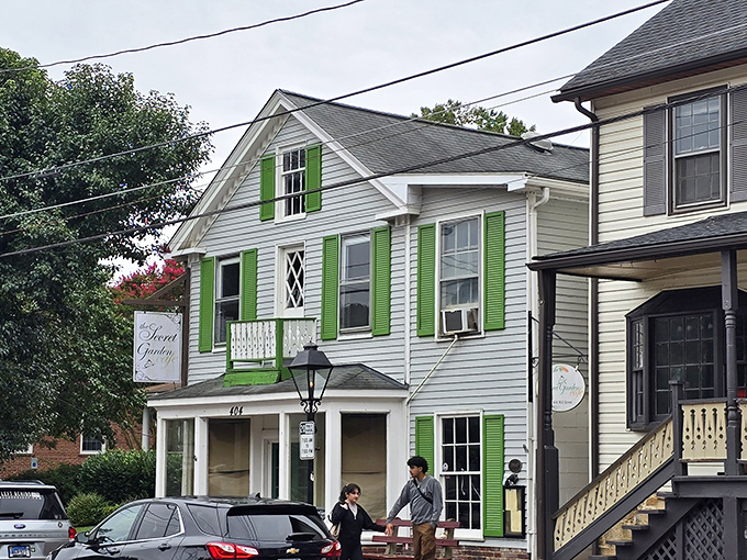 The charming white facade with vibrant green shutters beckons like a Southern grandmother inviting you in for Sunday dinner. Historic charm meets culinary magic.