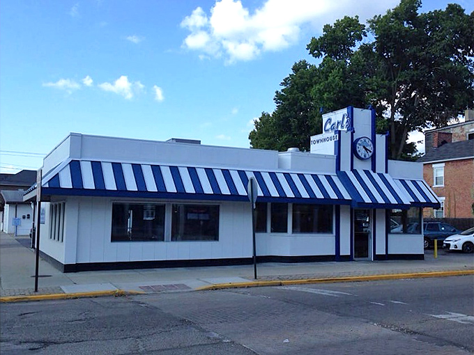 That iconic blue and white striped awning isn't just eye-catching—it's a time portal to when breakfast was king and calories weren't counted.