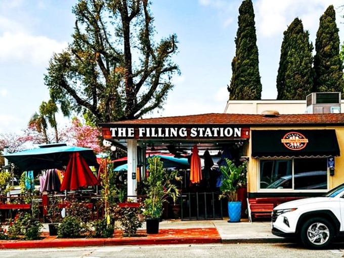 Another angle reveals the cafe's charming exterior, where lush greenery and colorful umbrellas create a perfect California breakfast retreat.