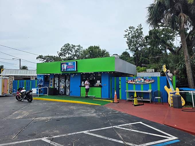 The vibrant green and blue exterior of Uncle Chicken's stands out like a tropical bird in New Smyrna Beach, promising flavor adventures before you even step inside.