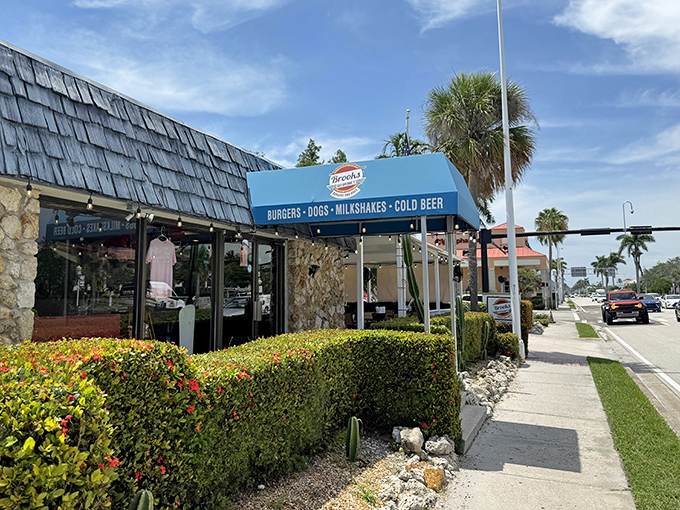 The blue awning beckons like a lighthouse for the burger-obsessed. This unassuming stone exterior houses Naples' worst-kept culinary secret.