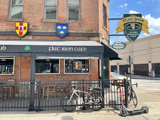 The Flat Iron Cafe stands proudly in Cleveland's Flats district, its brick facade and heraldic shields offering just a hint of the Irish hospitality waiting inside.