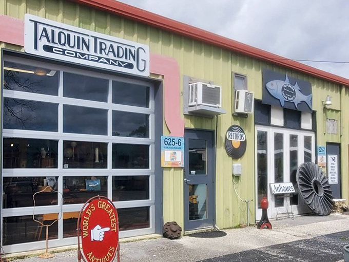 The iconic yellow facade with its industrial garage door and metal fish sculpture offers the first hint that ordinary shopping ends here.