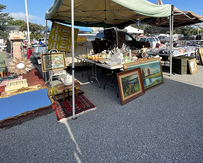 A treasure hunter's paradise awaits under these canopies, where framed landscapes and vintage glassware sit patiently for their second act in someone's home.