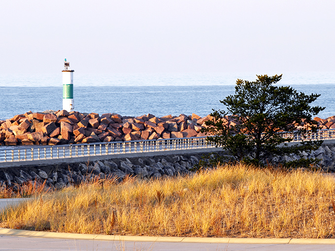 The breakwater pier stretches toward the horizon like a concrete invitation to adventure, complete with a lighthouse that practically winks at you.